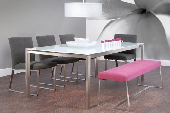 A simple modern dining table with a slim metal base and a glass or wood ...